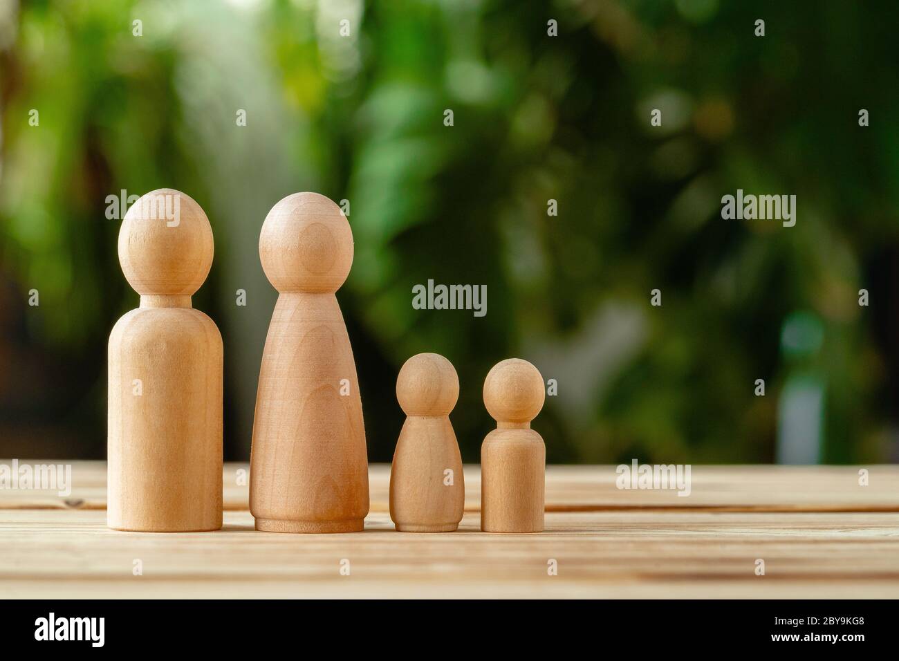 Wooden little figures of people. Family concept Stock Photo - Alamy