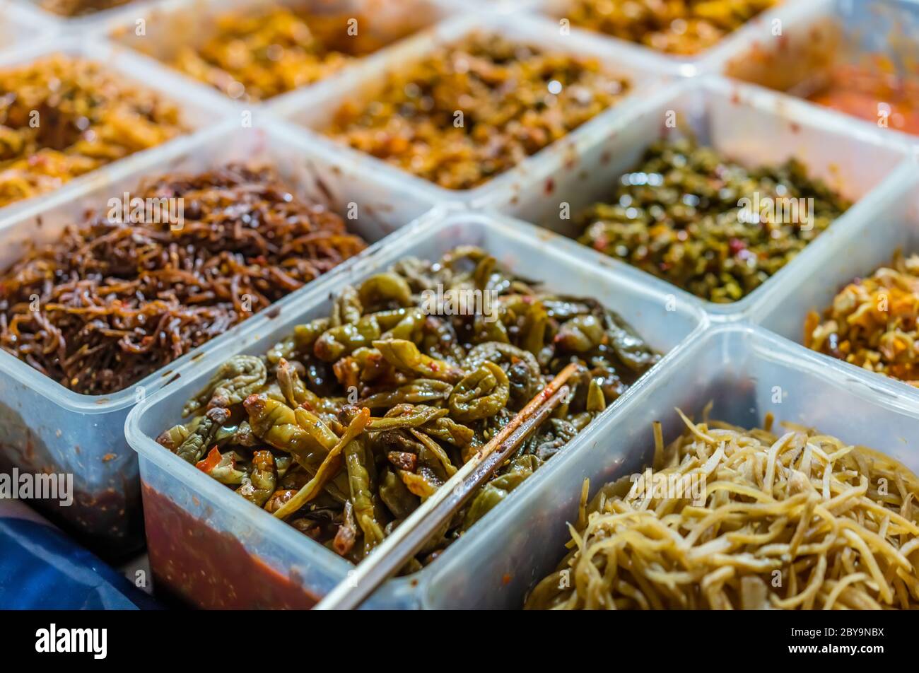 Buffet of plastic boxes with spicy additions to food ordered from an ...