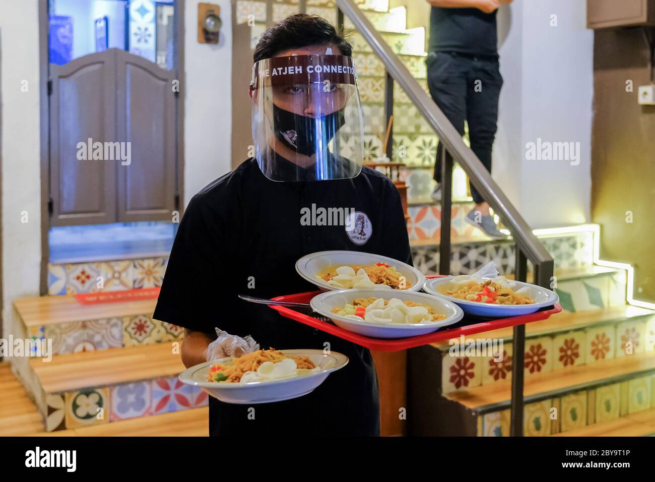 Jakarta, Indonesia. 09th June, 2020. A Waitress wear face shield serves ...
