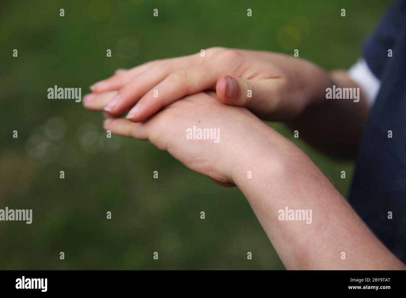 Child washing hands outside using hand sanitiser during Covid 19 ...