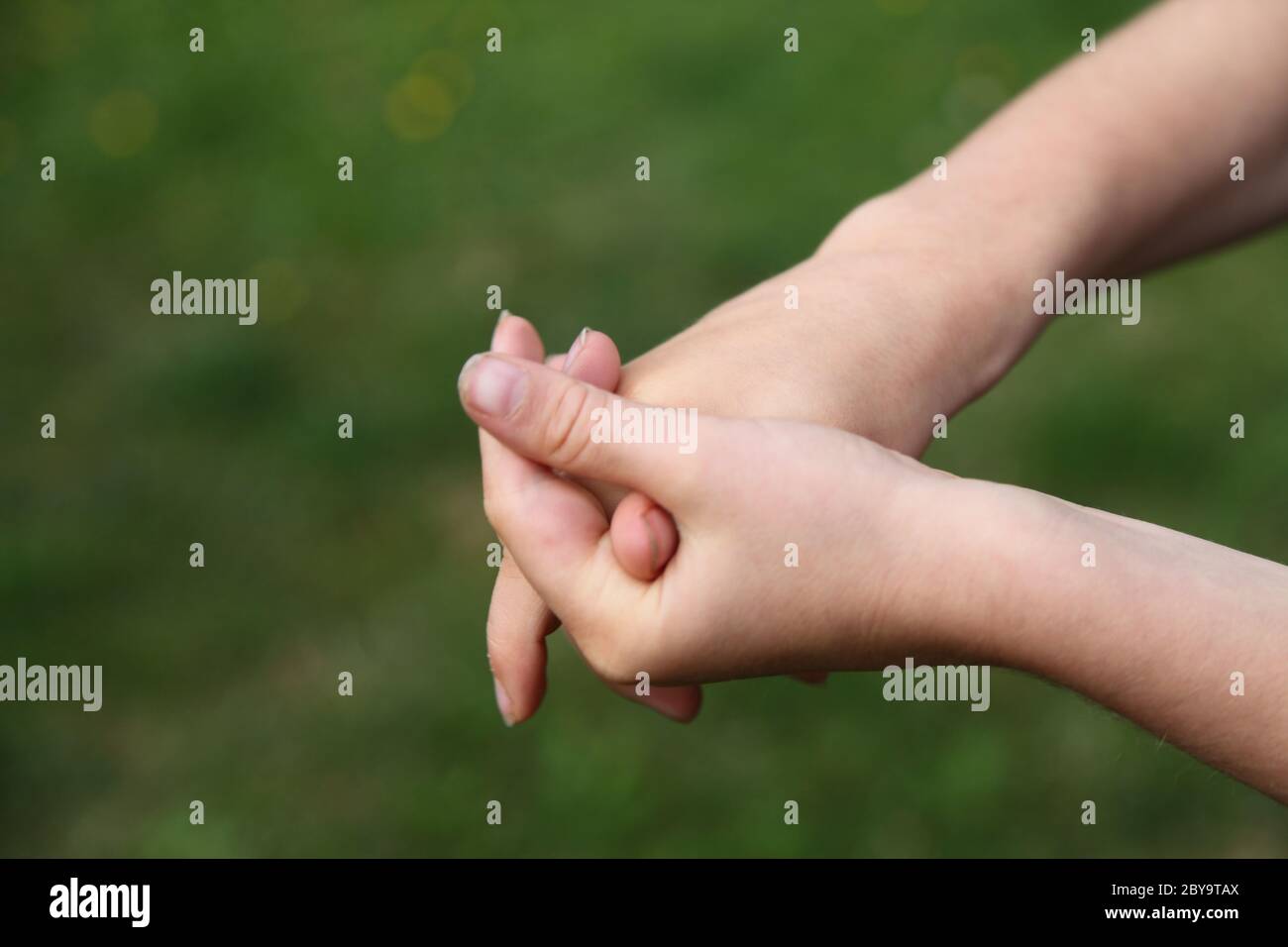 Child washing hands outside using hand sanitiser during Covid 19 ...