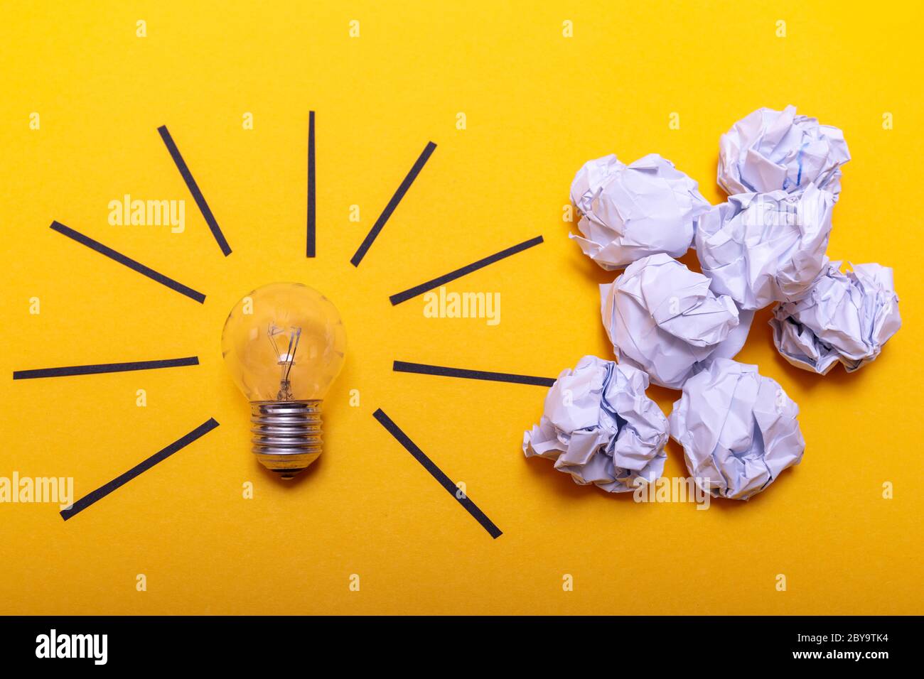 Inspiration concept crumpled paper and light bulb metaphor for good ...