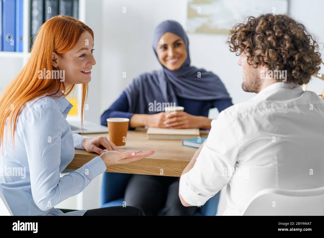 Diverse workmates talking during a coffee break Stock Photo - Alamy