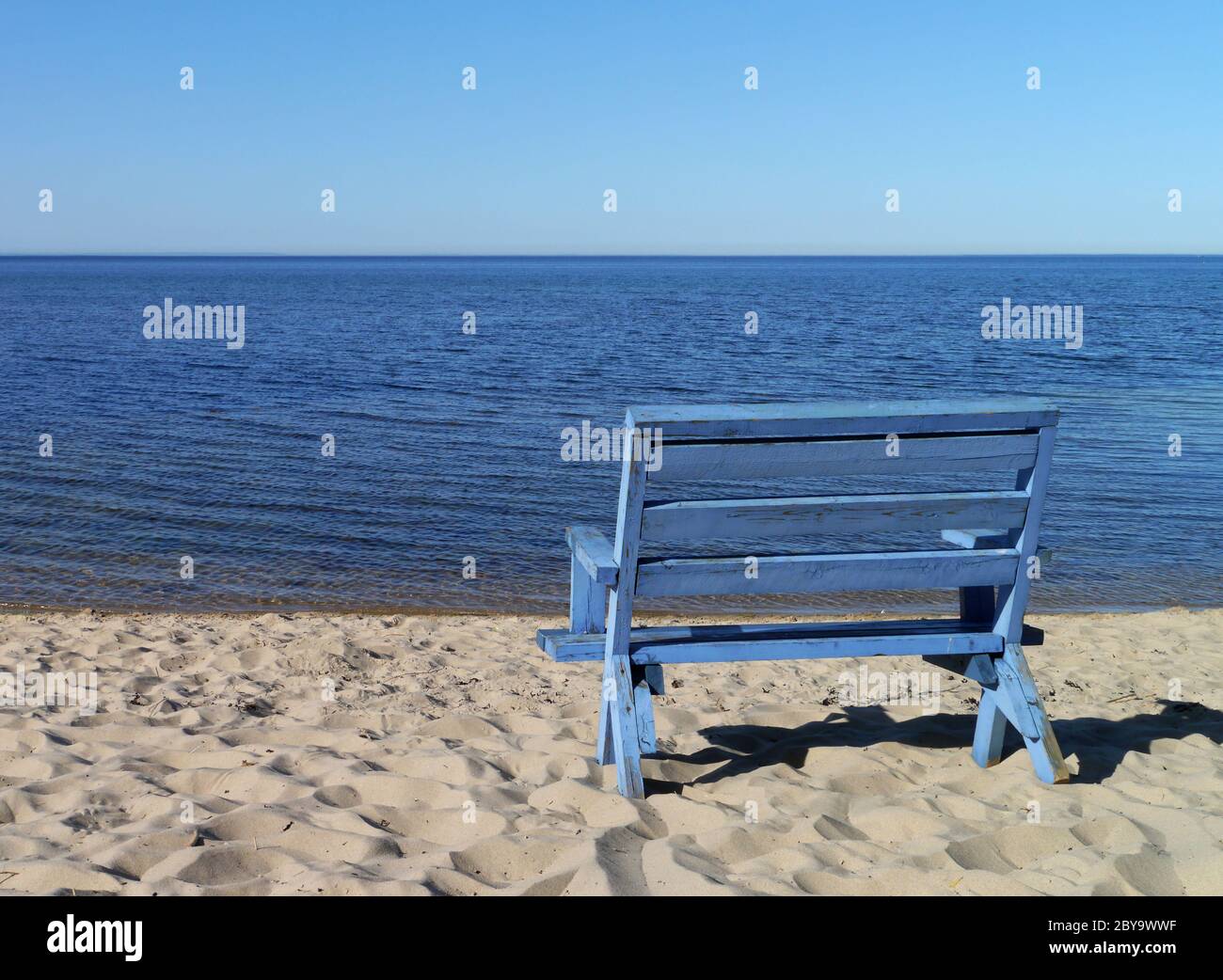 wooden bench on sandy beach Stock Photo - Alamy