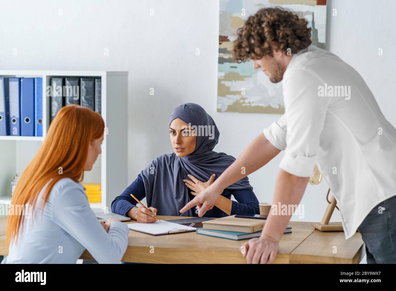 Hot discussion in the office. Coworkers talking about a project and ...