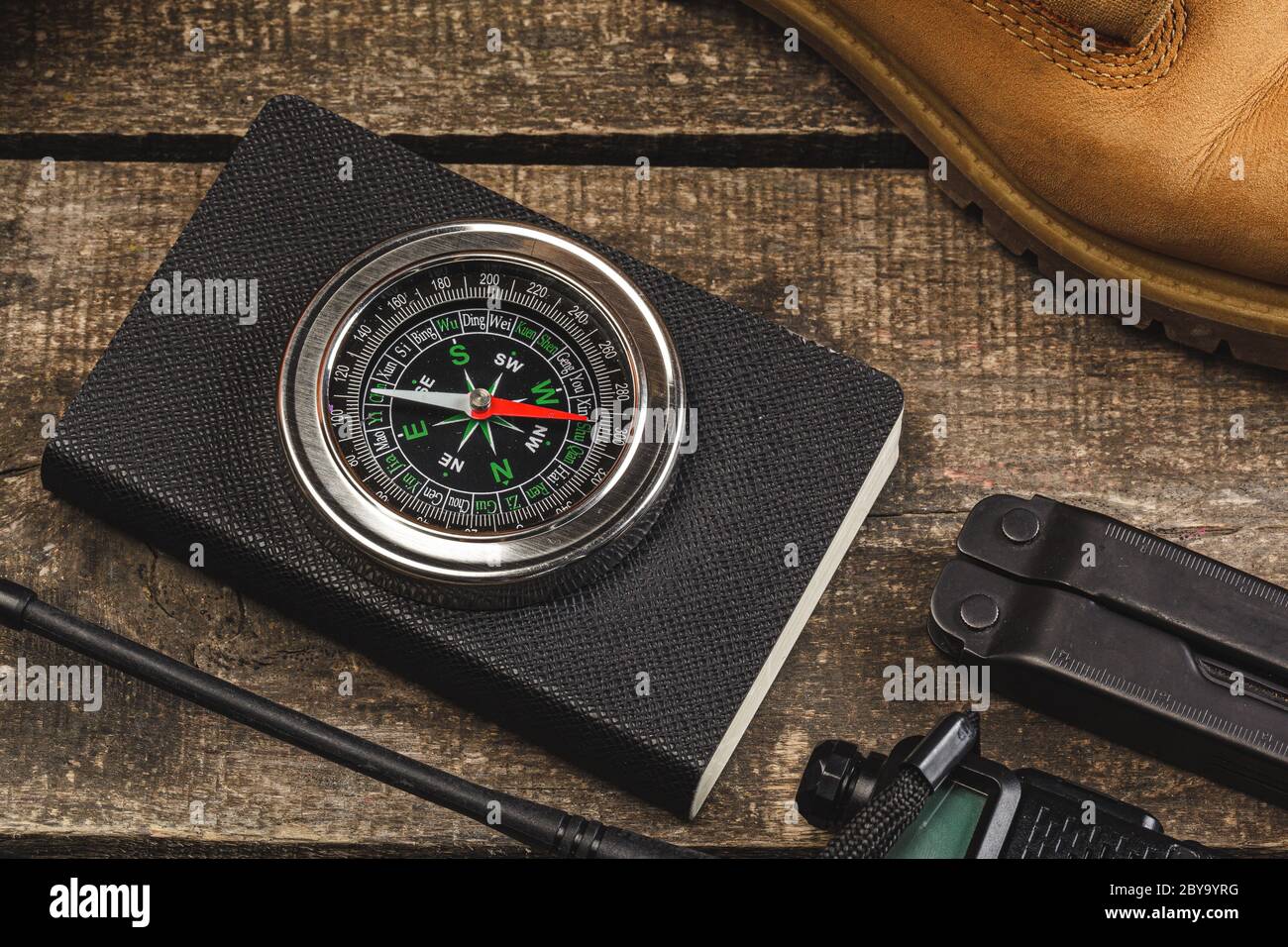 Compass surrounded by mountain gear tools on wooden background Stock ...