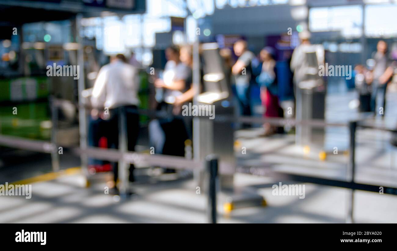 Blurred image of passengers in line on flight check-in at airport ...