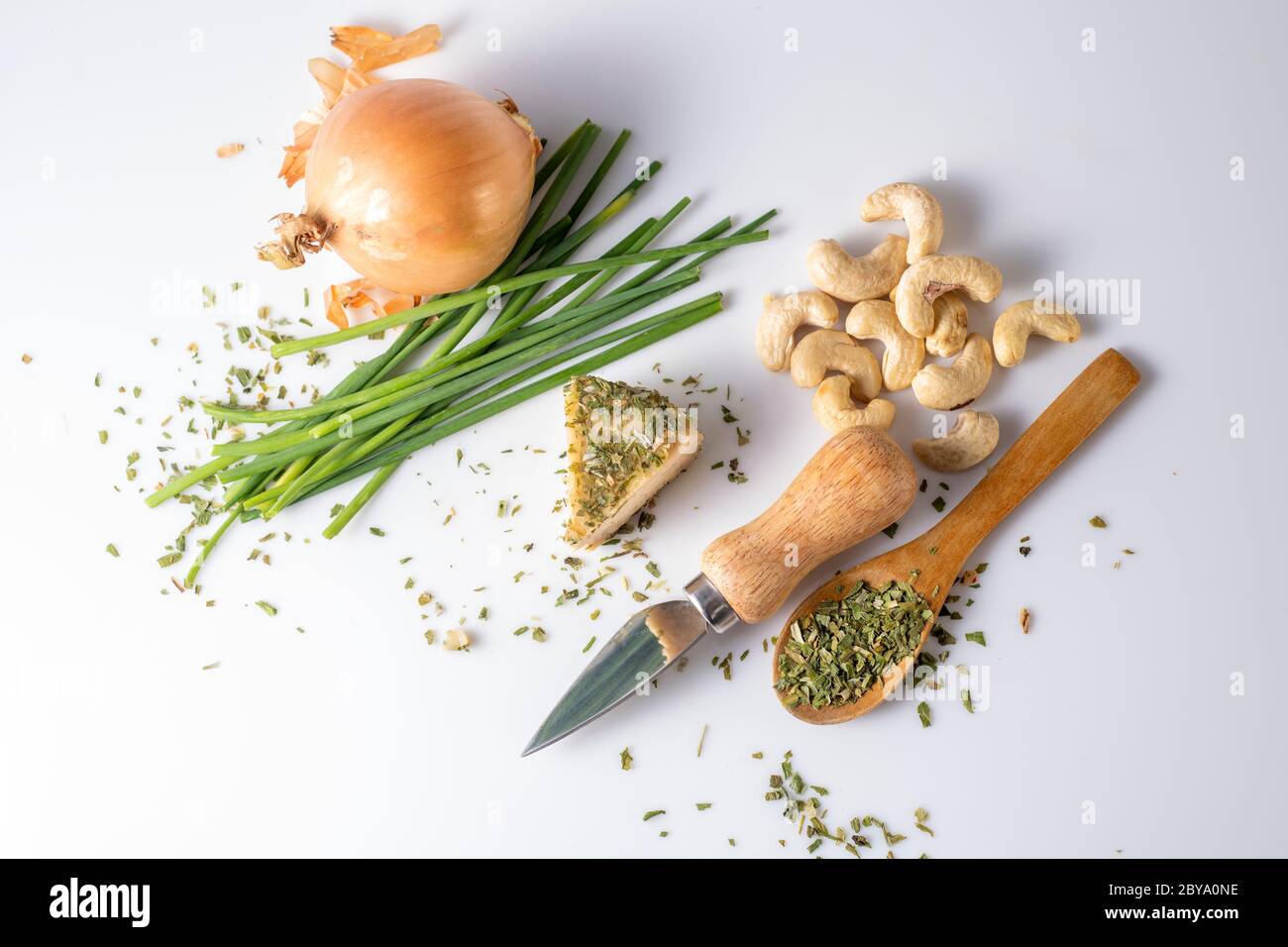 Cheese with some ingredients over a table Stock Photo - Alamy