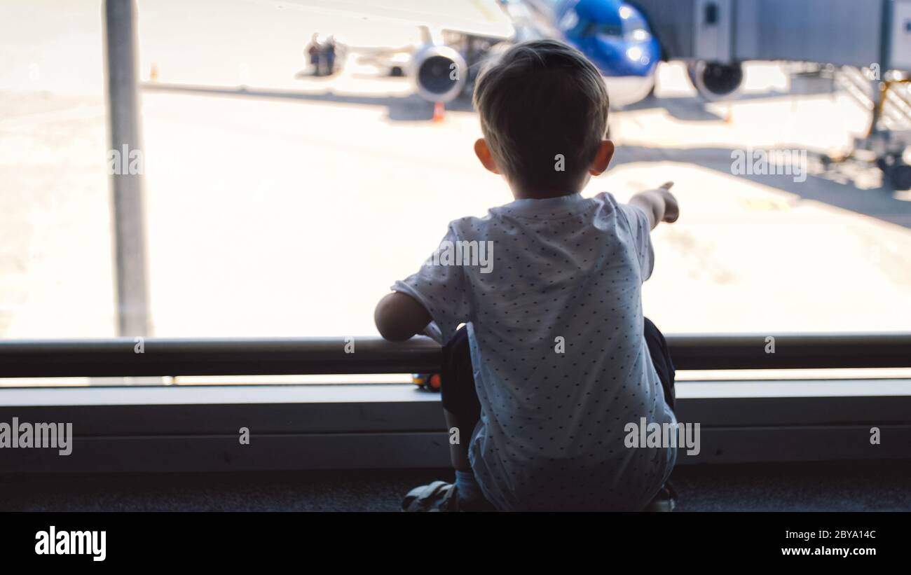 Little boy pointing with finger on airplane at airport Stock Photo - Alamy