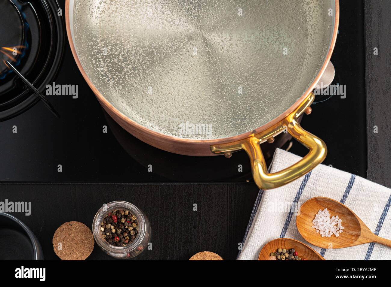 Copper pot with boiling water on a gas stove Stock Photo - Alamy