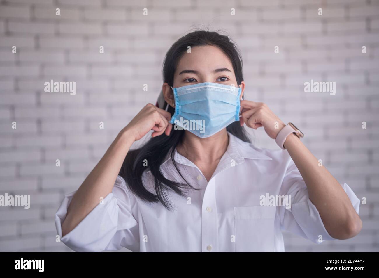 beautiful young asian woman wearing face mask to protect covid19 virus ...