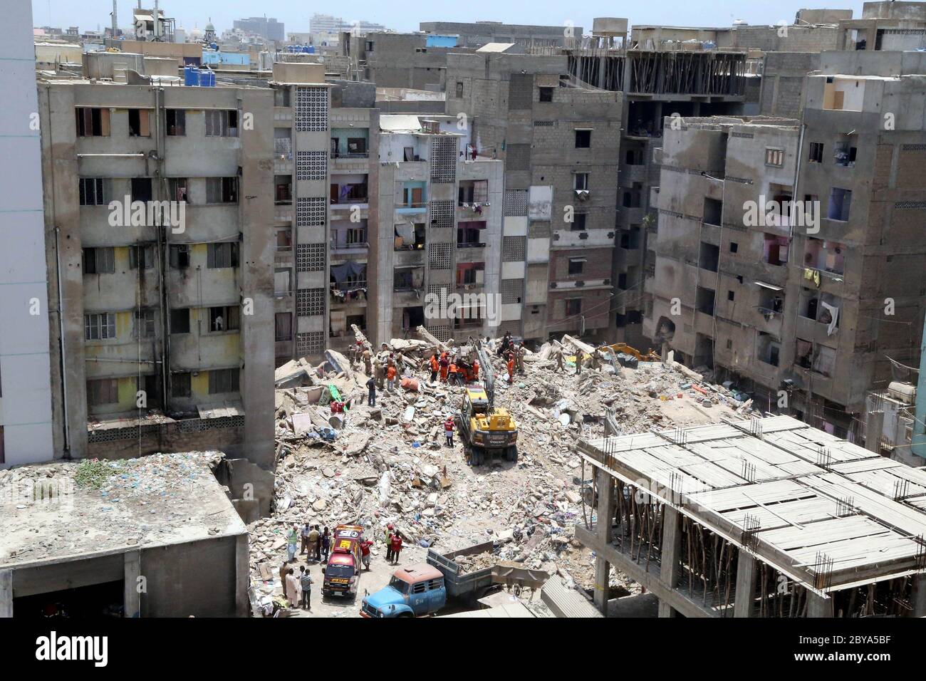 Karachi, Pakistan. 9th June, 2020. Rescuers work at the site where a ...