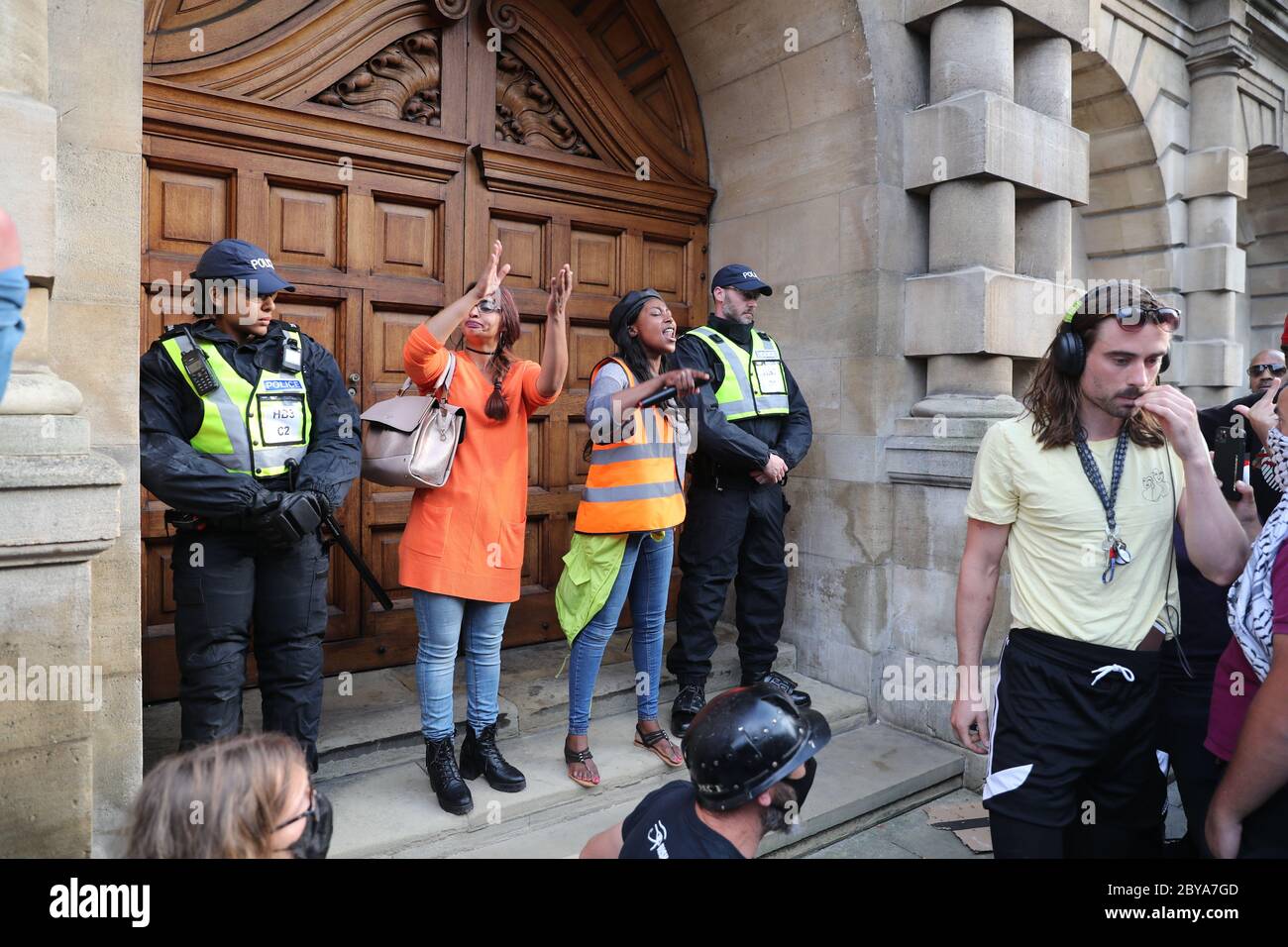 People during a protest calling for the removal of the statue of 19th ...