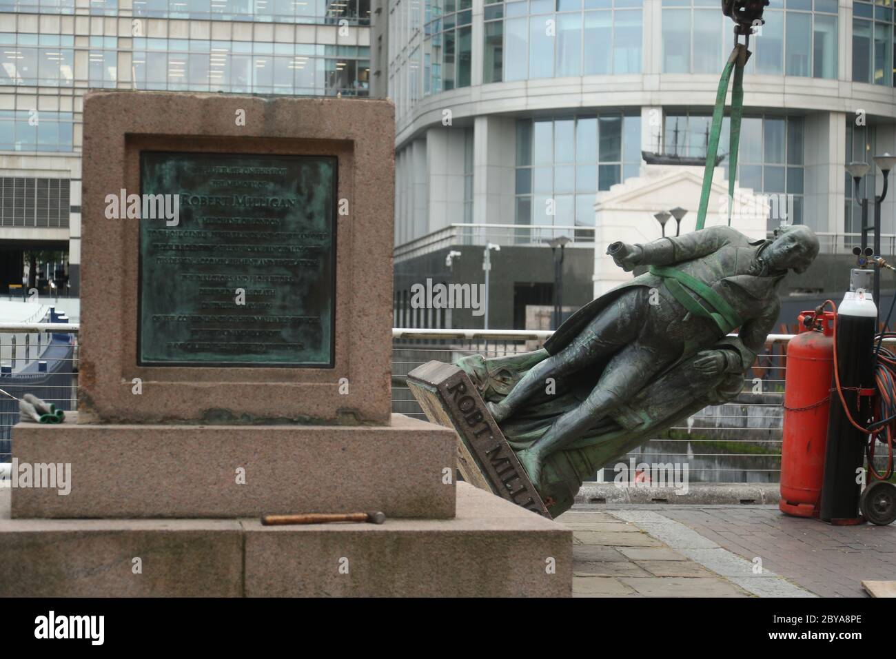 Workers prepare to take down a statue of slave owner Robert Milligan at ...