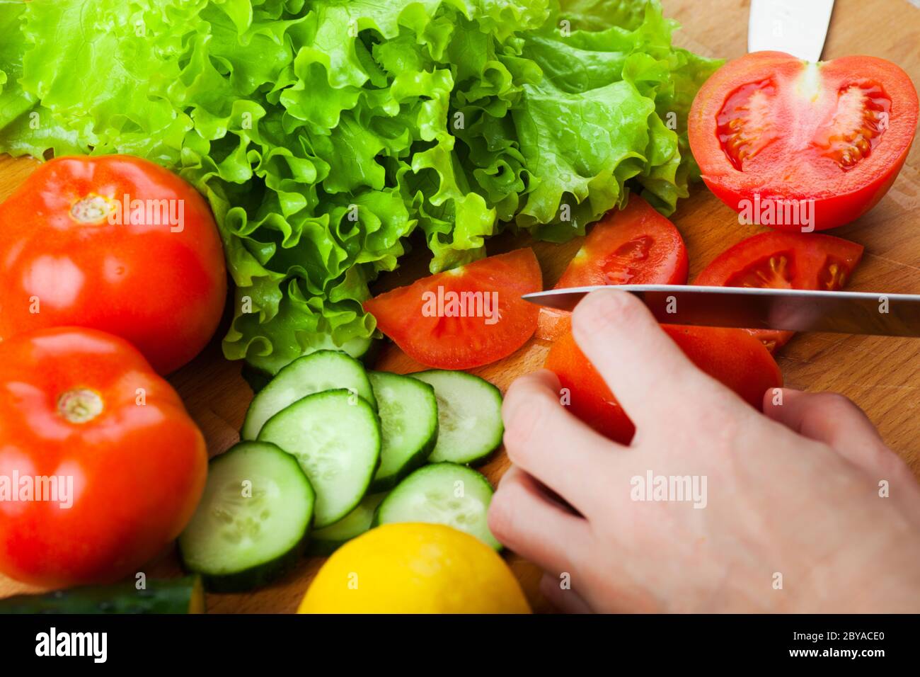 Hand holding knife cutting vegetables hi-res stock photography and ...