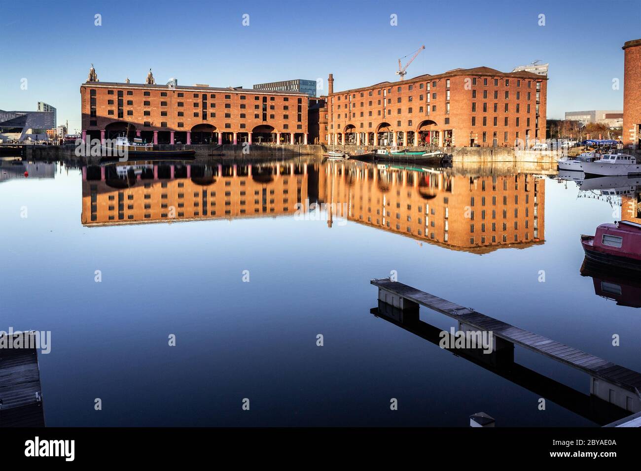 Red brick buildings, former warehouses reflected in the water, Albert ...