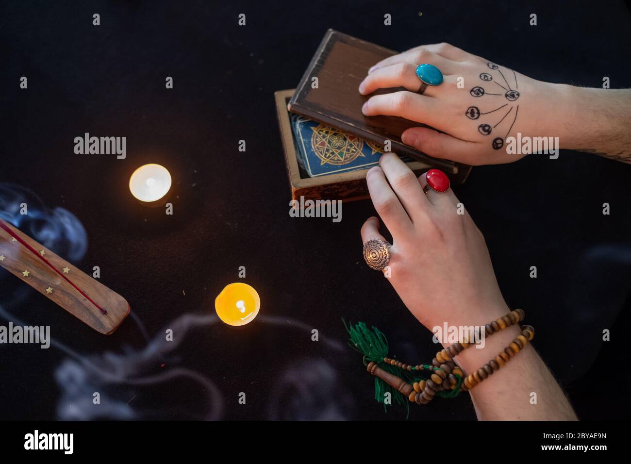 Fortune teller using tarot cards on black background Stock Photo - Alamy