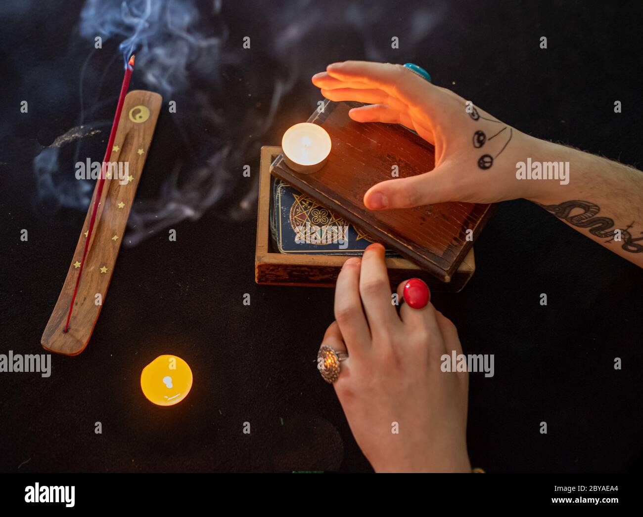 Fortune teller using tarot cards on black background Stock Photo - Alamy