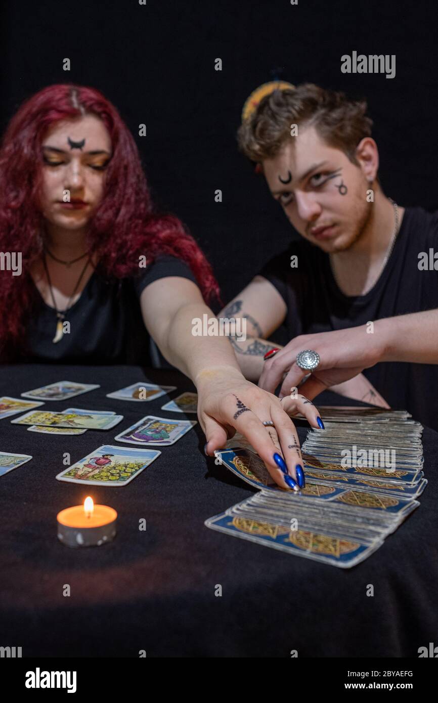 Fortune teller using tarot cards on black background Stock Photo - Alamy