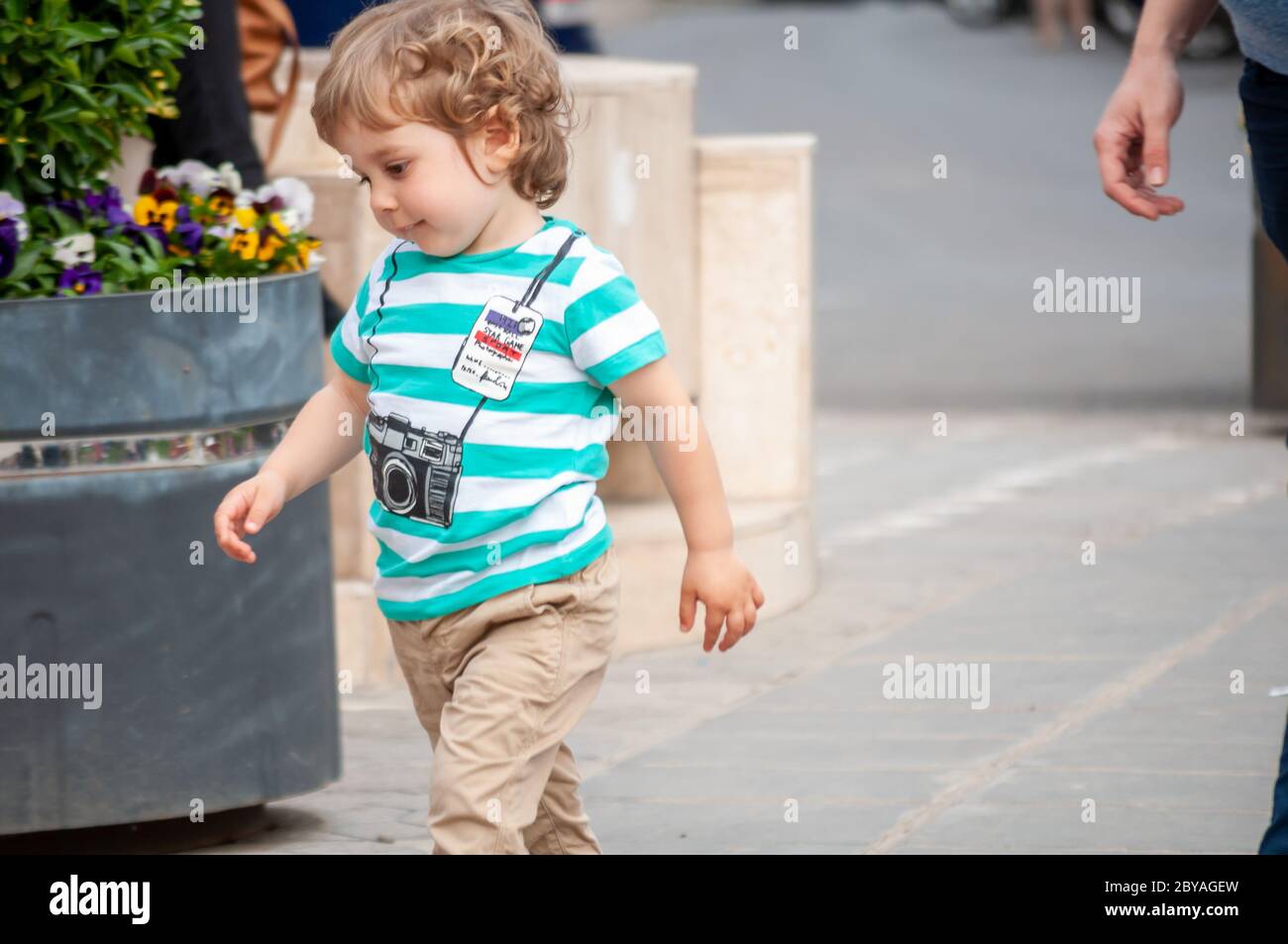 Timisoara, Romania - April 13, 2016: Kid walking on the street. Real ...