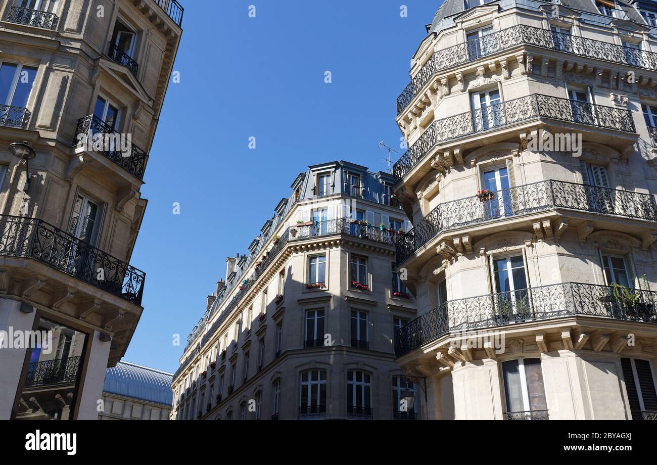Traditional French houses with typical balconies and windows. Paris ...