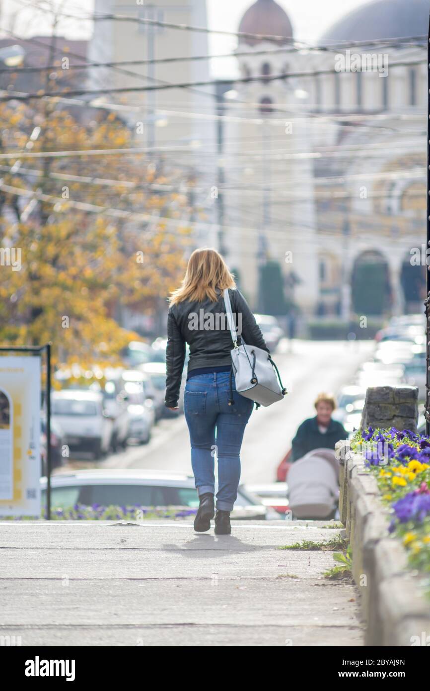 Woman walking on the street. Real people Stock Photo - Alamy
