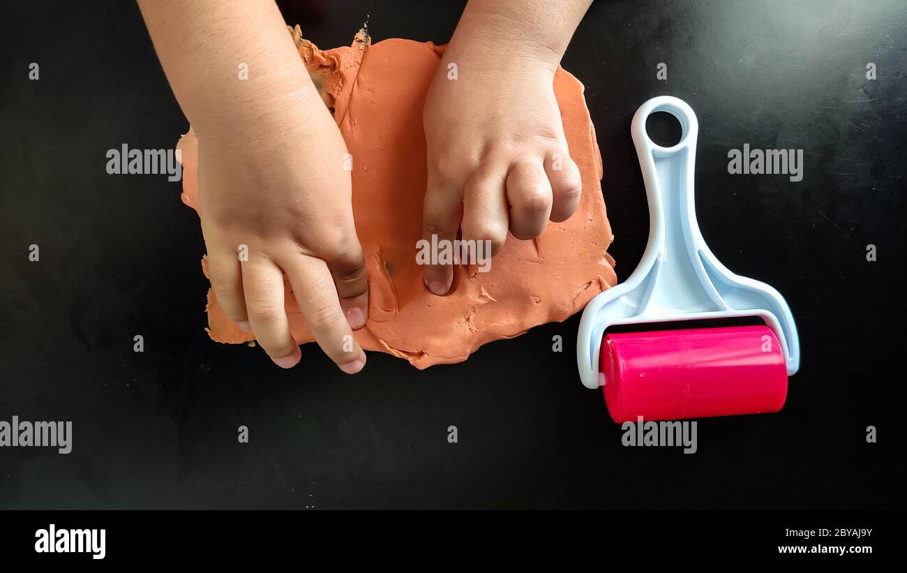 Homemade clay. Child hands playing with colorful clay. Homemade ...