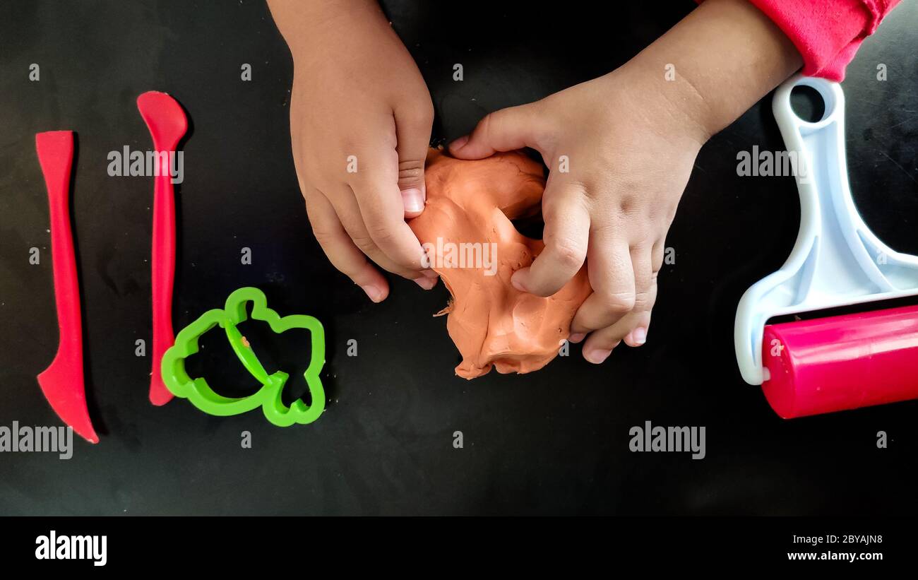 Homemade clay. Child hands playing with colorful clay. Homemade ...