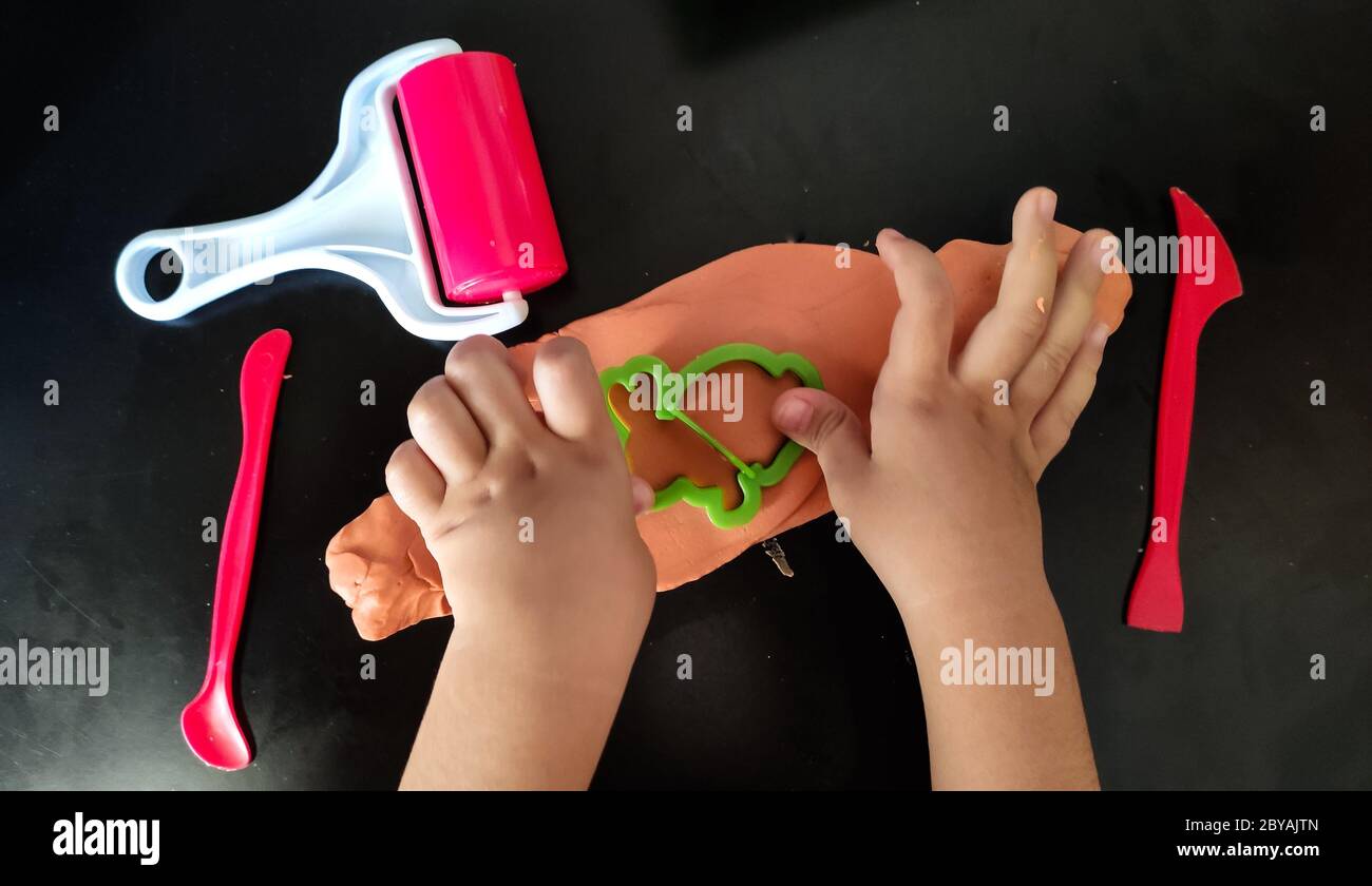 Homemade clay. Child hands playing with colorful clay. Homemade ...