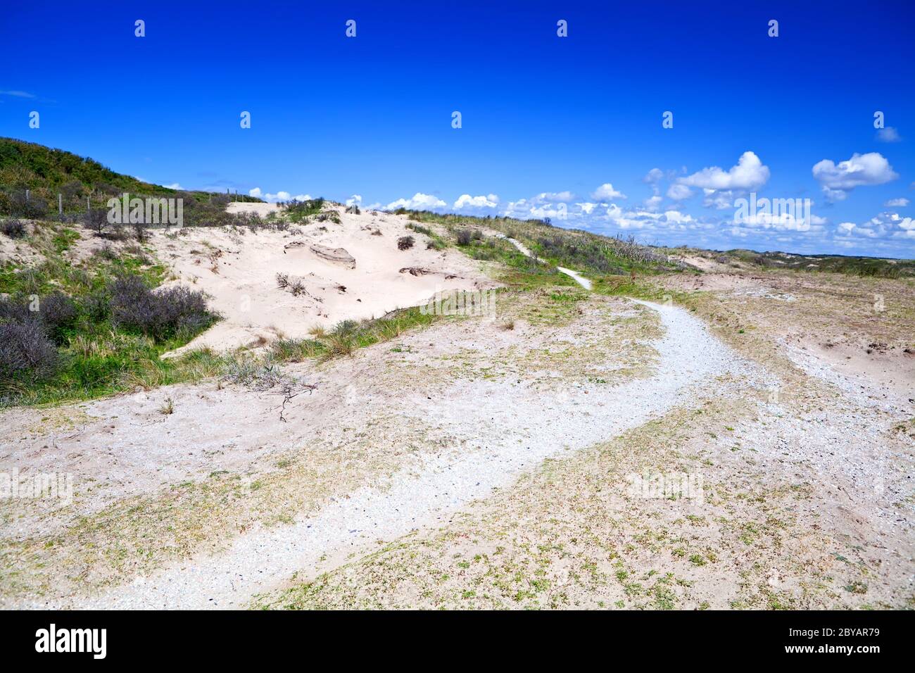 path in sand dunes over blue sky Stock Photo - Alamy