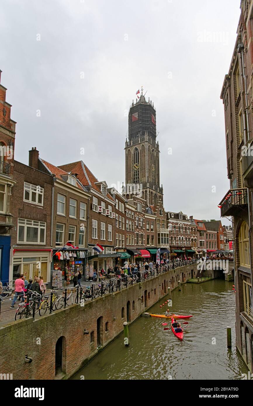 Downtown Utrecht, the Netherlands, with canal with shops, people and ...