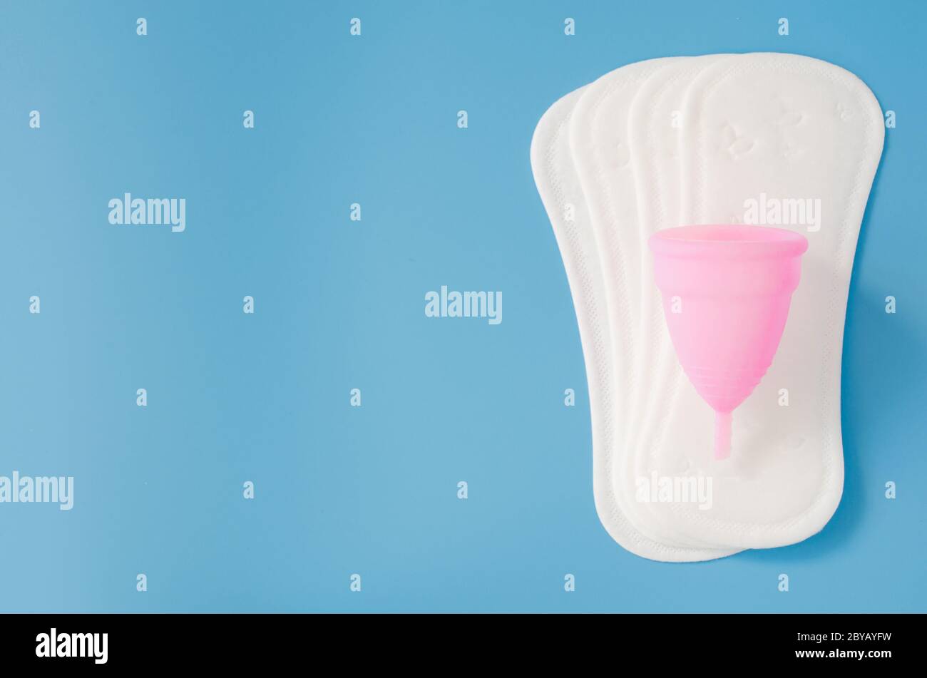 Feminine sanitary pad and menstrual cup. Concept of feminine hygiene ...