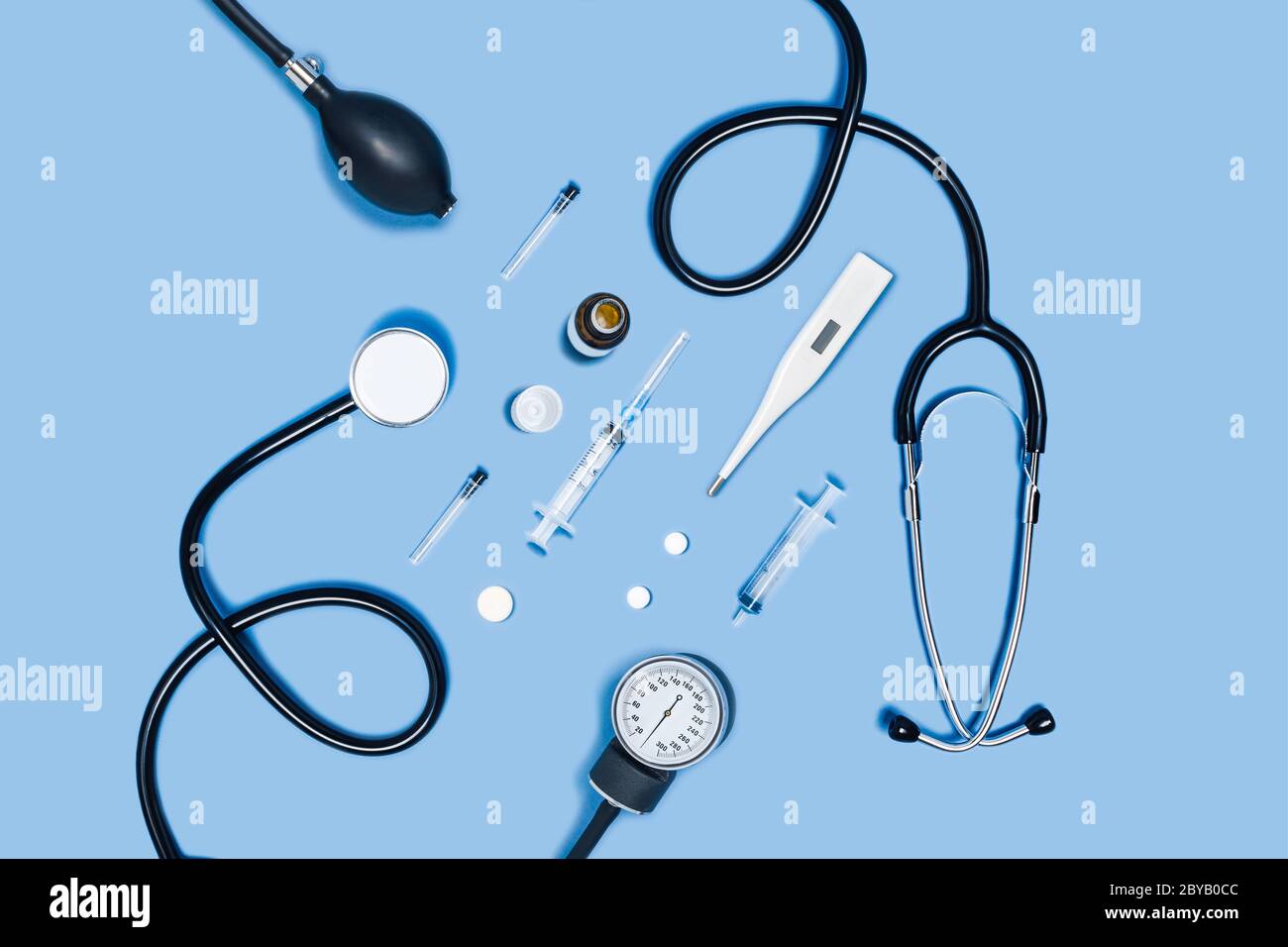 Medical different accessories on blue background: stethoscope, syringes ...