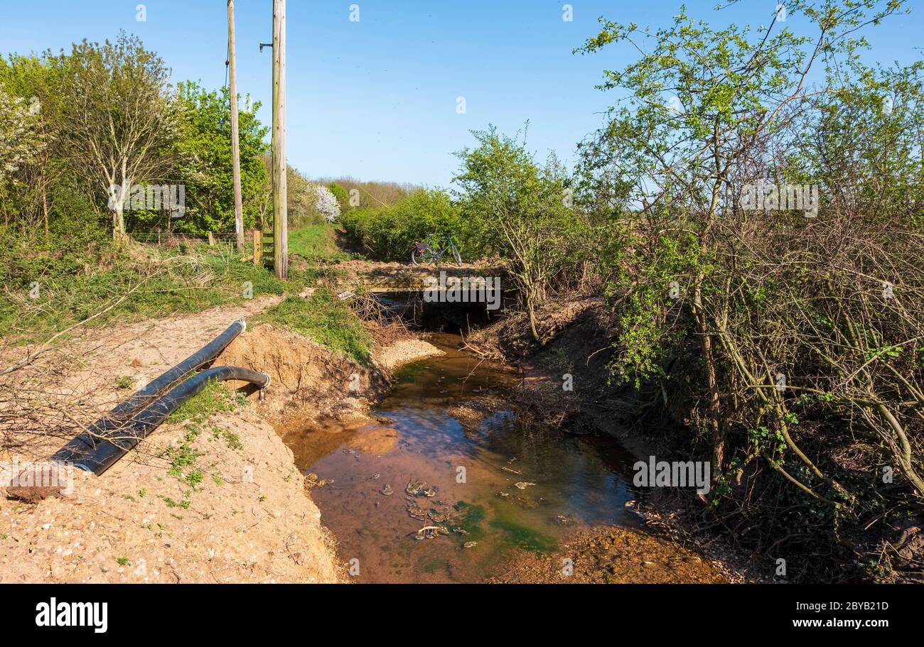 Small shallow stream and plank bridge Stock Photo - Alamy