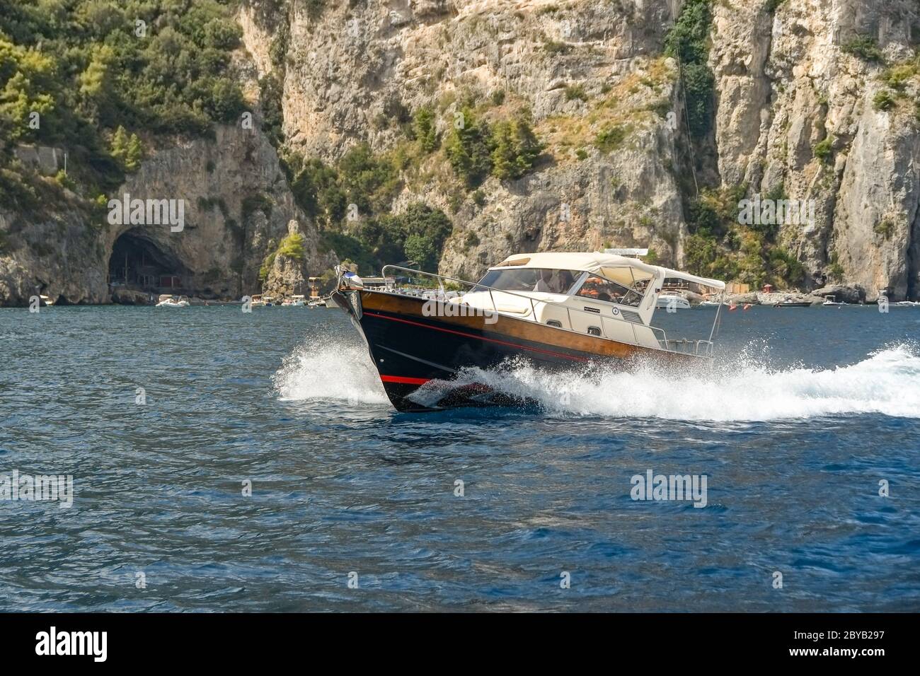 AMALFI COAST, ITALY - AUGUST 2019: Small private motor boat at speed ...