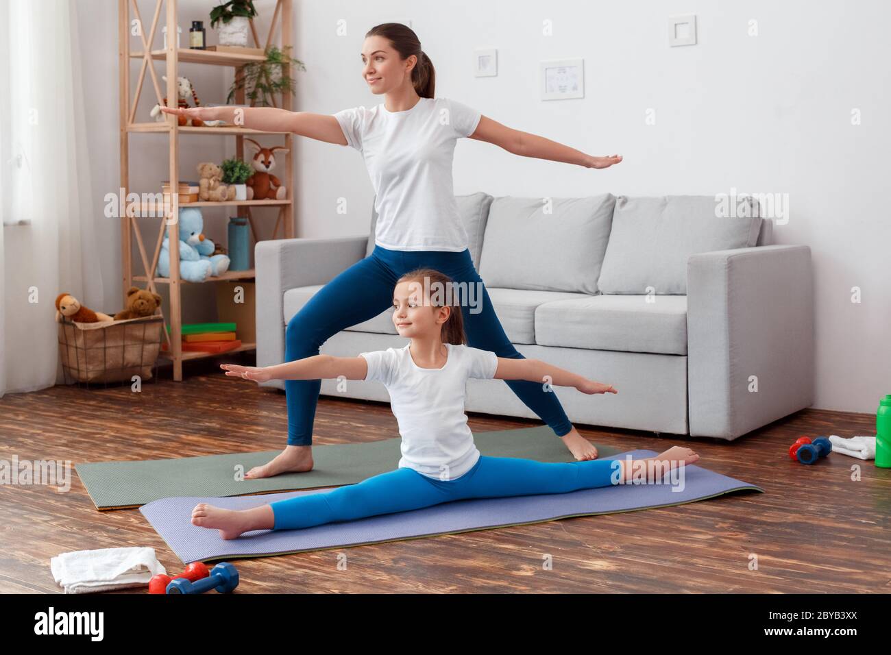 Healthy Lifestyle. Mother stretching legs while daughter in sportswear ...