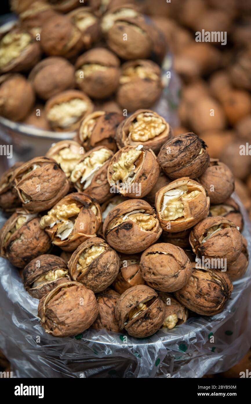 Bunch of fresh walnuts in a bowl for sale on a street market in China ...
