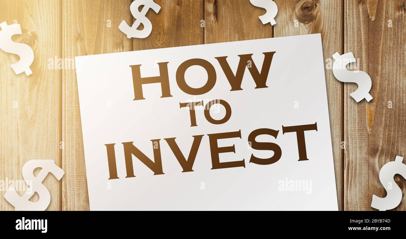 How to invest words written on copybook page and paper dollar signs ...