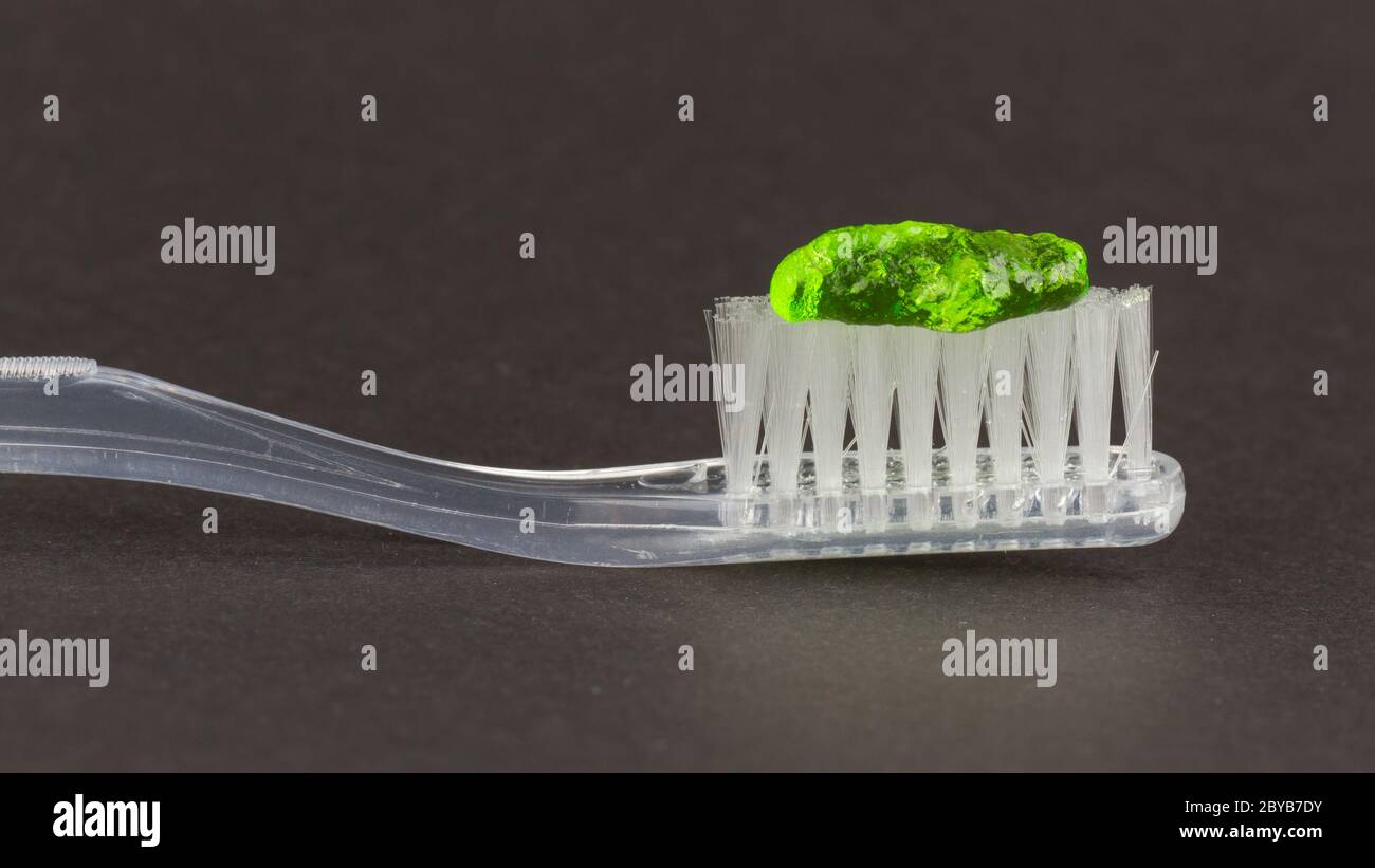 Toothbrush and green toothpaste isolated Stock Photo - Alamy