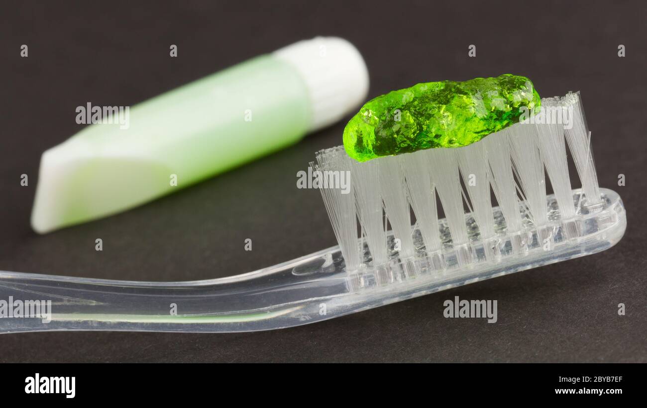 Toothbrush and green toothpaste isolated Stock Photo - Alamy