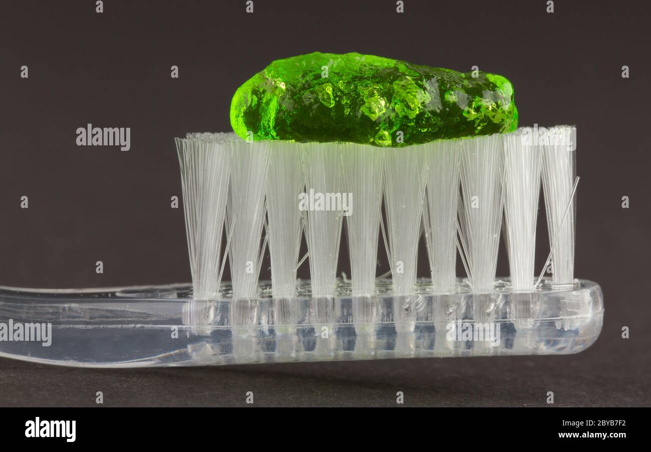Toothbrush and green toothpaste isolated Stock Photo - Alamy