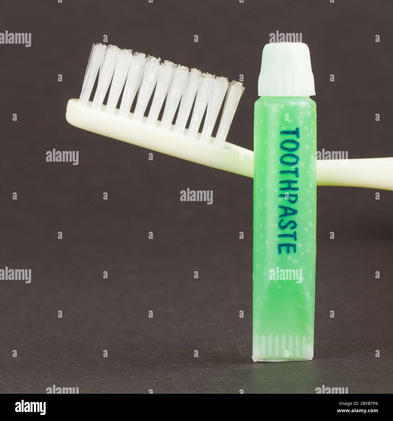 Toothbrush and green toothpaste isolated Stock Photo - Alamy