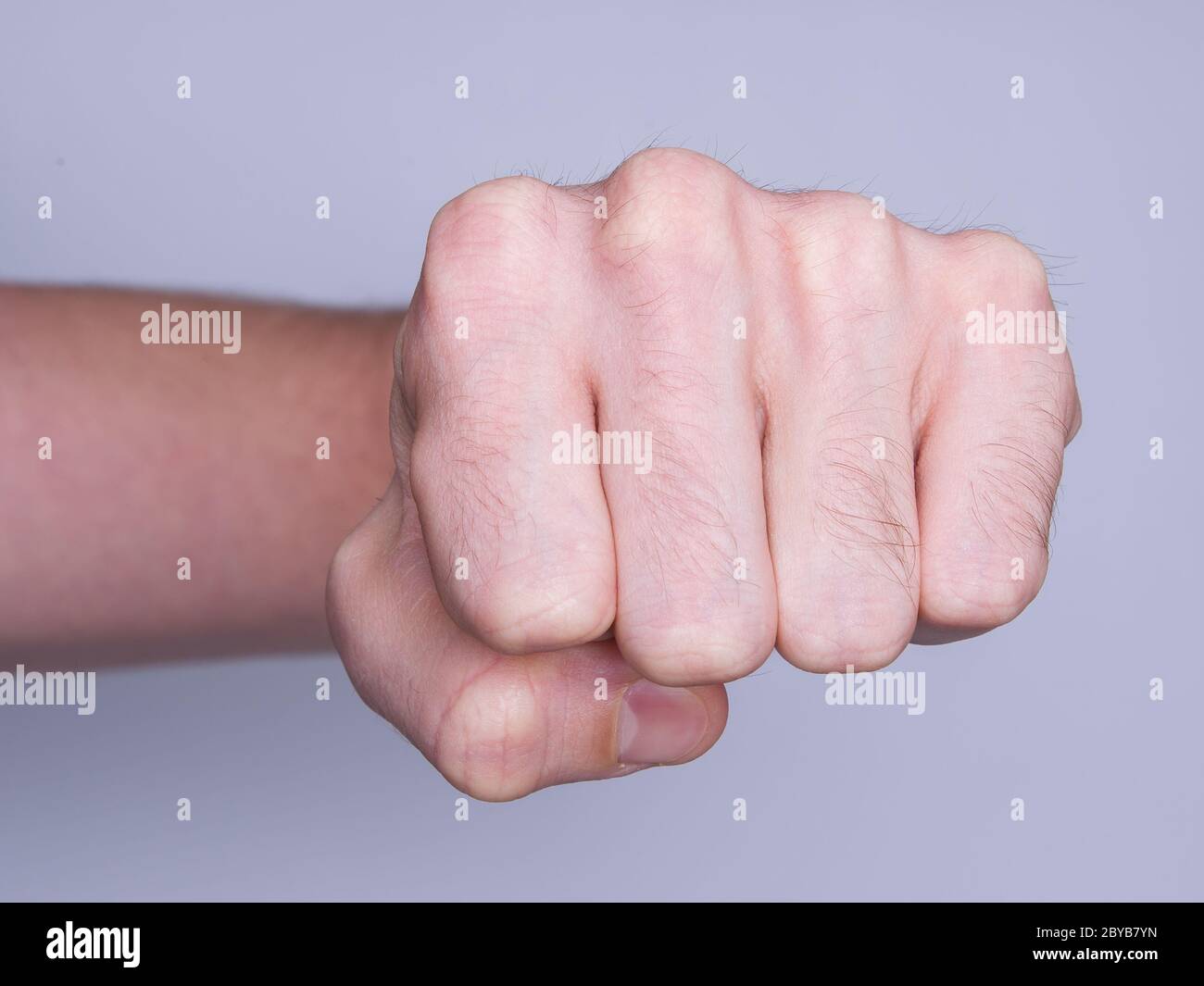 Fist of a man punching Stock Photo - Alamy