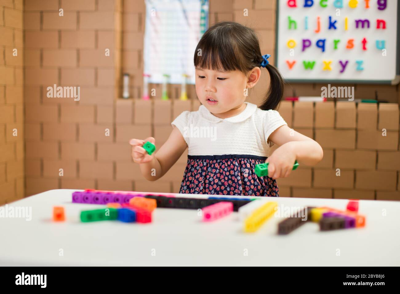 toddler girl play number blocks for homeschooling Stock Photo - Alamy
