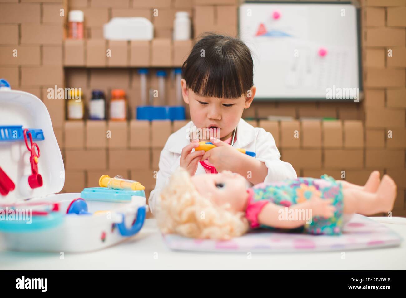 toddler girl pretend play doctor role at home Stock Photo - Alamy