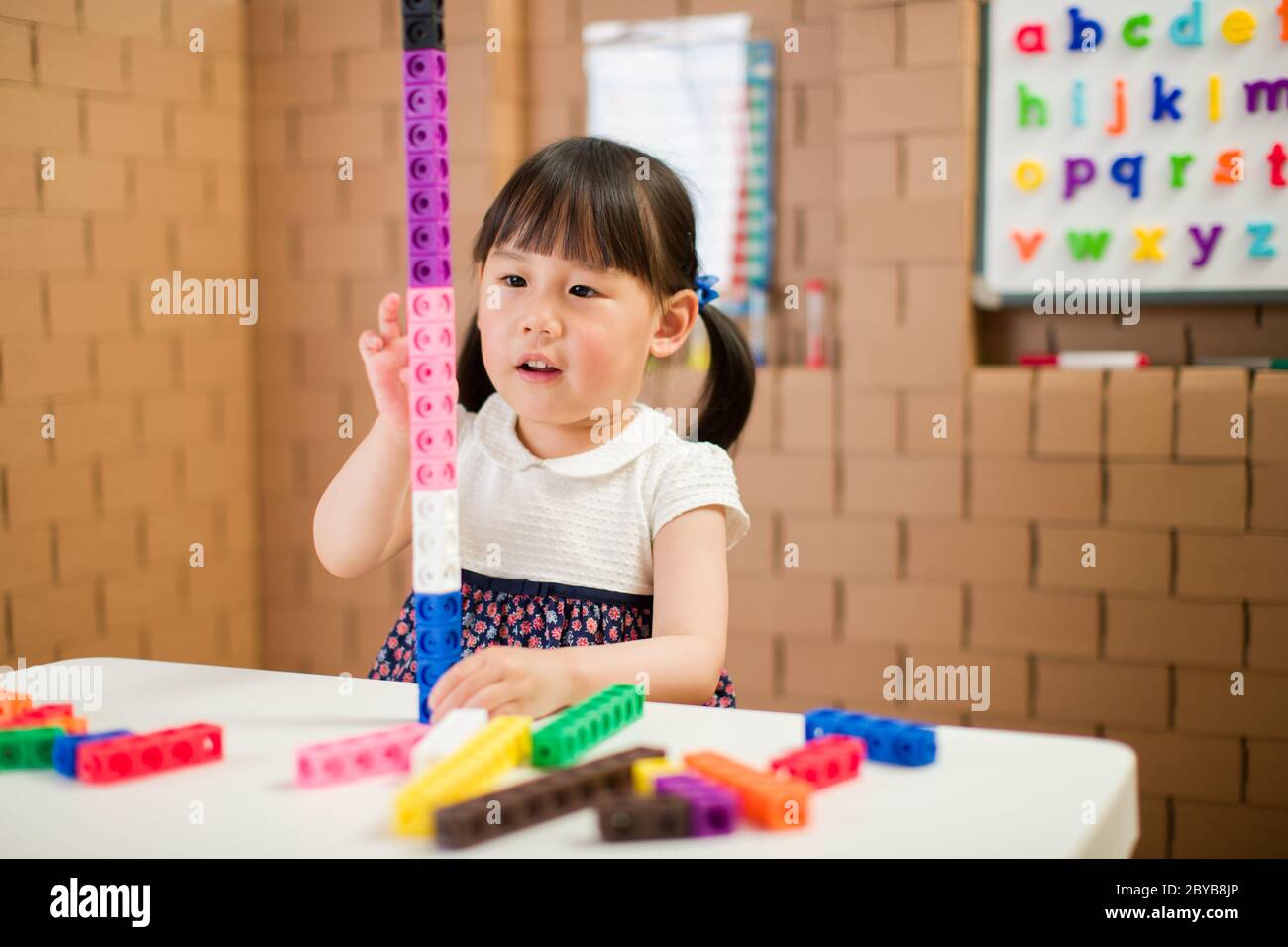 toddler girl play number blocks for homeschooling Stock Photo - Alamy