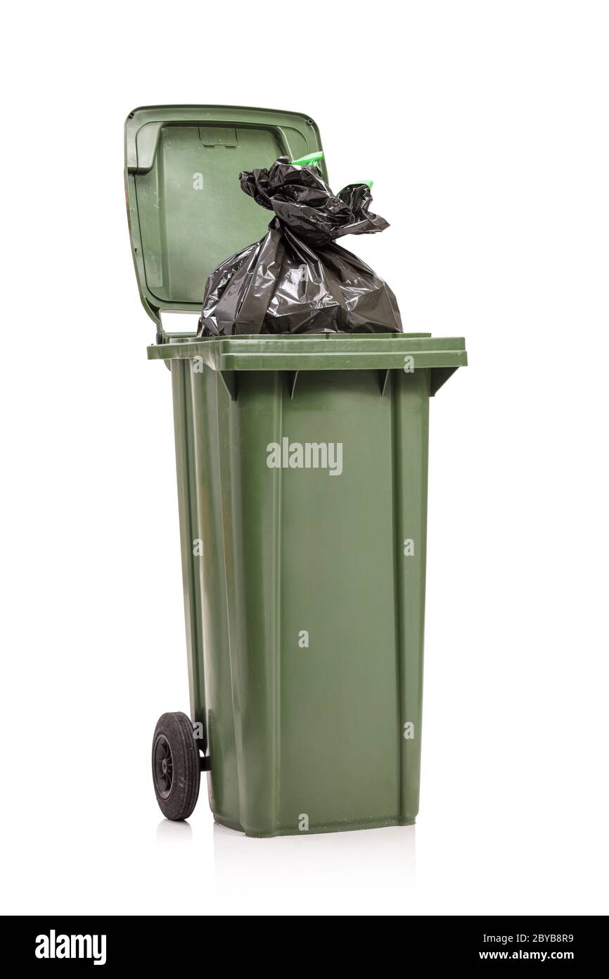 Studio shot of a green garbage bin with a plastic bag inside isolated ...
