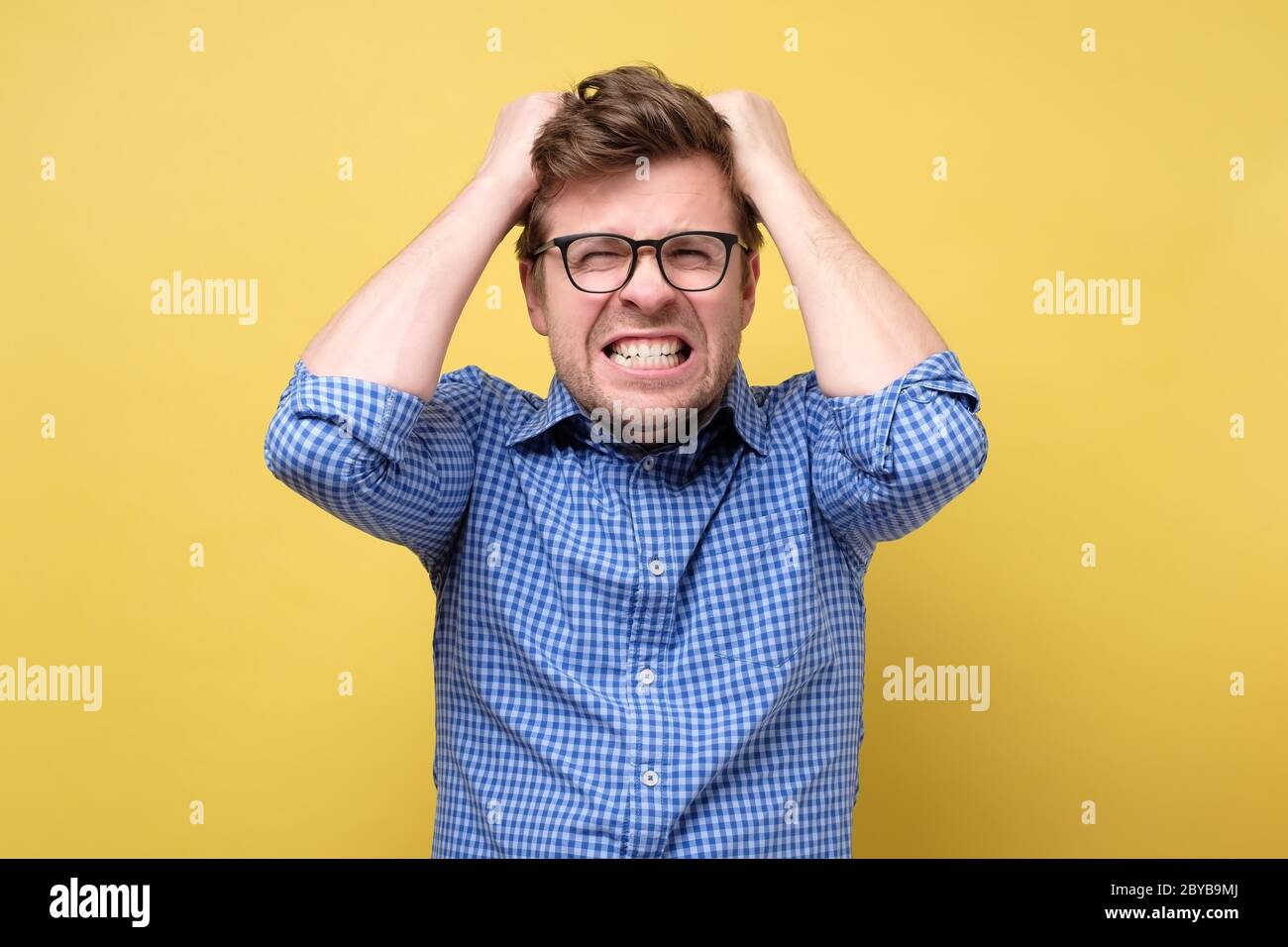 Young caucasian man in shock trembling from horror fear. Negative ...