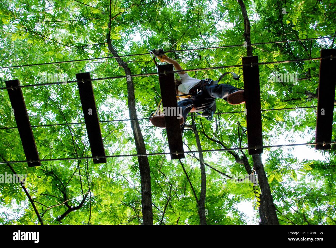 Crossing a suspended bridge with ropes Stock Photo - Alamy