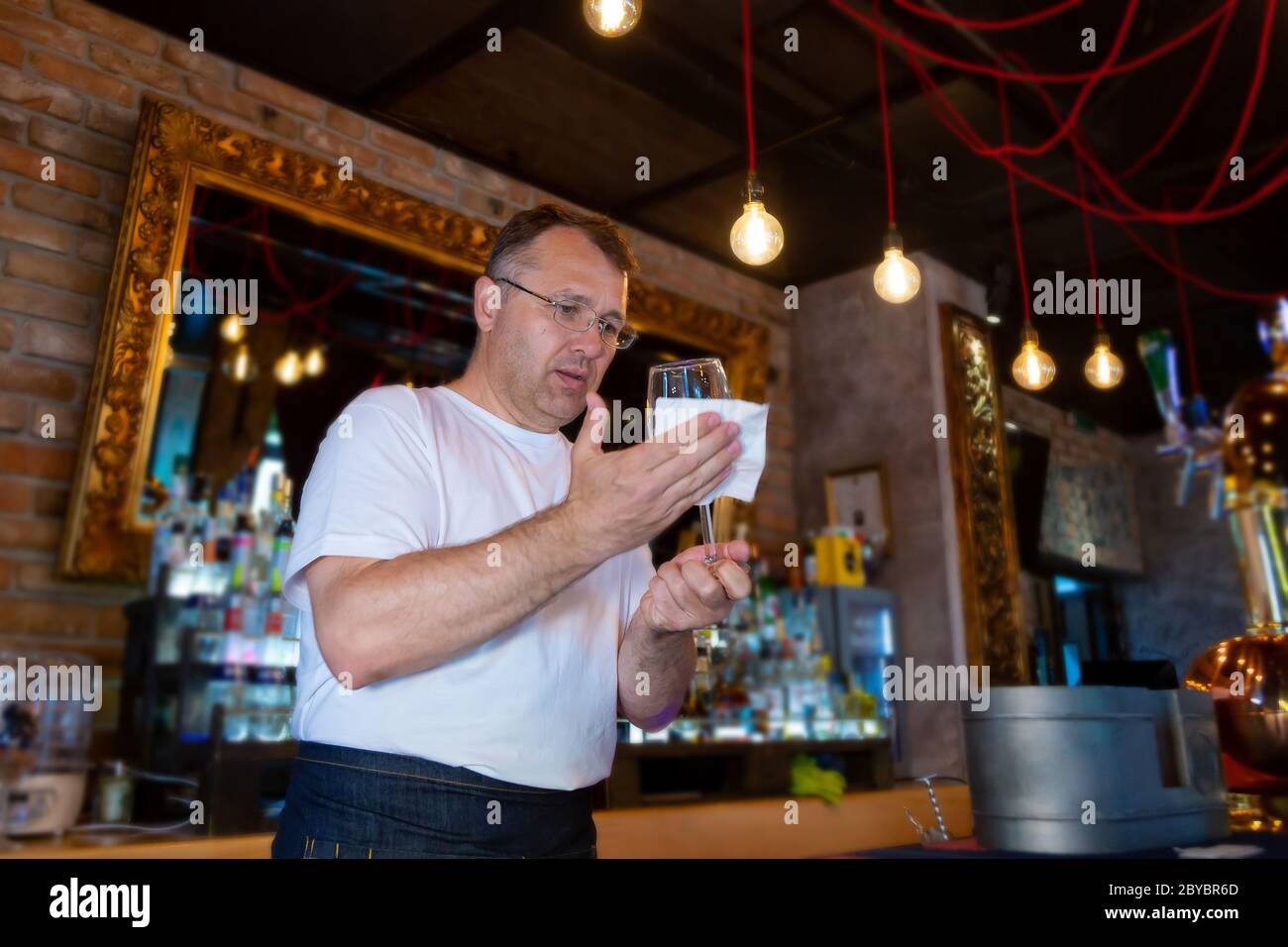 Bartender at the Bar Cleaning a Glass Stock Photo - Alamy